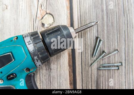 Screwdriver screws on wooden board Stock Photo - Alamy