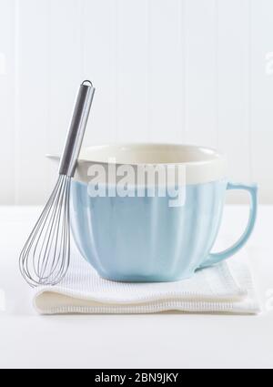 Blue mixing bowl with wisp for baking on white background. Kitchen ...