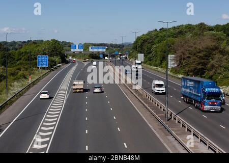M4 motorway with cars and lorries in Wales with overhead gantry showing ...