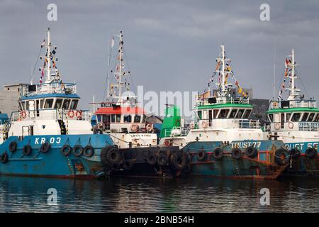 Horizontal view of some colorful ships moored in the port at sunrise ...