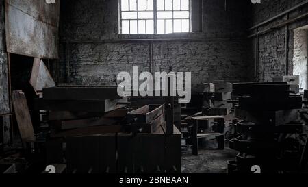 Messy room with stacks of metal and a concrete brick wall of a building ...