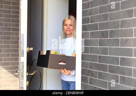 Medicine woman courier in mask and gloves with medical pills purchases ...