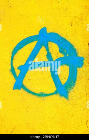 Symbol of Anarchy painted on a yellow wall. Copy space for moodboard ...