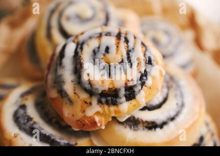 Closeup picture of delicious Poppy snail pastries with a sugar glaze on ...