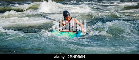Guy in kayak sails mountain river. Whitewater kayaking, extreme sport ...