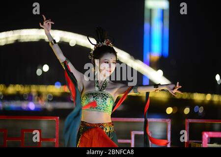 A performer plays Dunhuang Flying Apsaras Dance, which drew inspiration ...