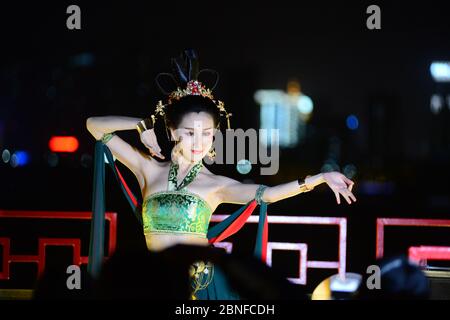 A performer plays Dunhuang Flying Apsaras Dance, which drew inspiration ...
