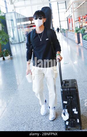 Chinese actor Fan Jinwei shows up at a train station before departure ...