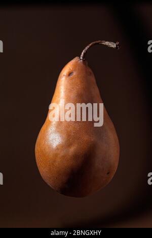 Fresh floating pear on brown background Stock Photo - Alamy