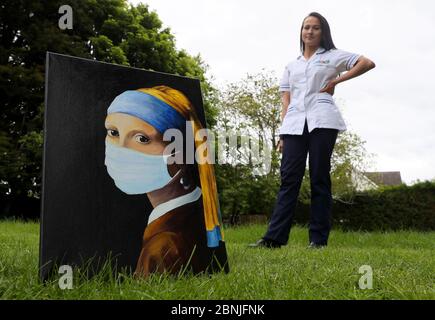 Trainee nurse Chloe Slevin, with her painting 'Corona Lisa' showing ...