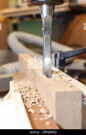 Cutting mortises in oak on a mortising machine, oak mortise Stock Photo ...