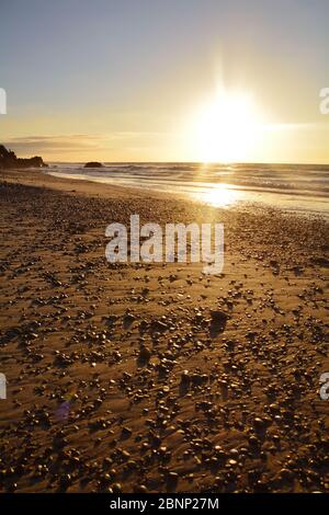 Beach at the time of sunset. warm yellow sky can be seen Stock Photo ...