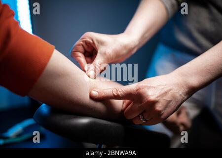 A nurse is inserting a syringe to a patient's vain Stock Photo - Alamy