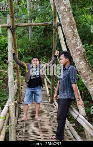 Low Angle Portrait Of Two Boys Having Fun Playing Outdoors Looking Down Into Camera With Lens ...