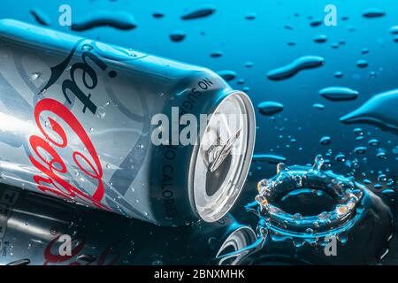Bedford,UK,May 16,2020. Coca Cola can with splashes of water on a black ...