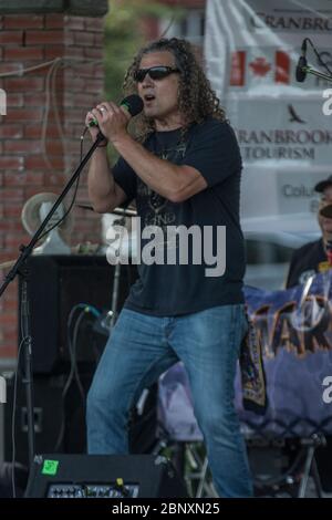 Lead singer, in rock band, performing at outdoor concert Stock Photo ...