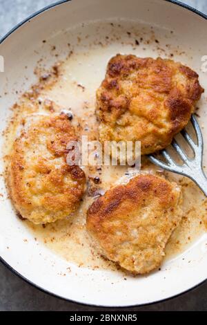 Schabowy. Breaded pork chop with fried egg and roast potatoes Stock ...