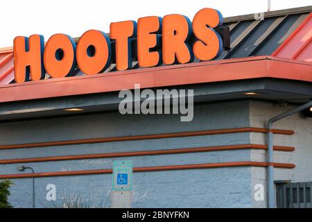 A logo sign outside of a Hooters restaurant location in King of Prussia ...