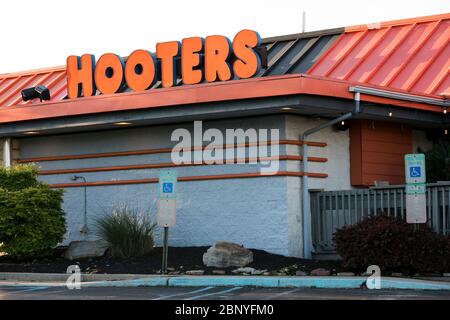 A logo sign outside of a Hooters restaurant location in King of Prussia ...
