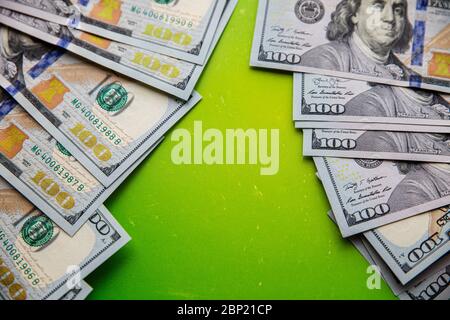 Stack of hundreds of dollars on bright green background with copy space ...