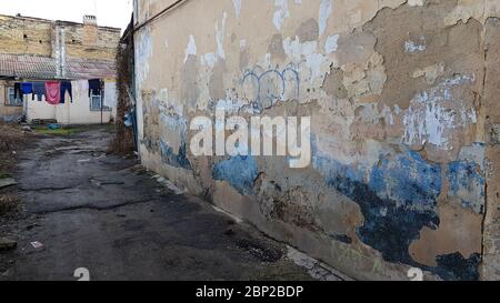 Ghetto court yard with hanging laundry clothes and weathered wall on ...