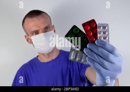 Blue protective mask on blister of tablets Stock Photo - Alamy