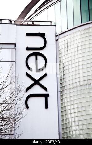 Next plc retail business clothing fashions store sign and open plan ...
