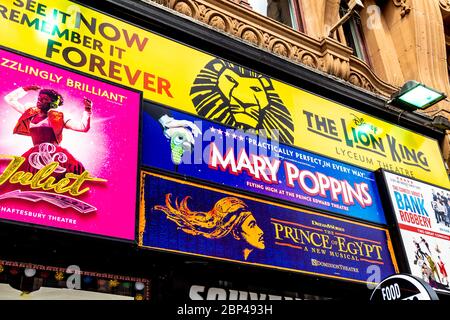 Posters advertising West End musicals on the back of newspaper kiosk in ...