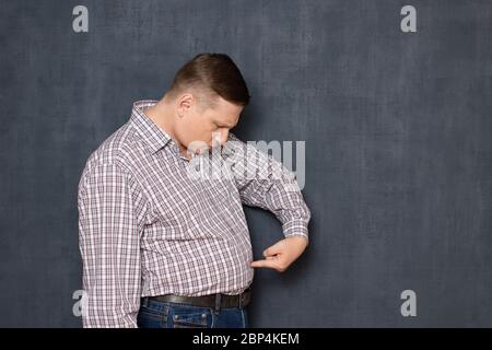 man pointing finger belly fat bored face isolated on white background ...