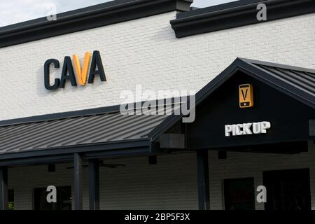 A logo sign outside of a Cava restaurant location in Chantilly ...