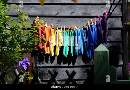 Colourful socks hanging on the washing line Stock Photo - Alamy