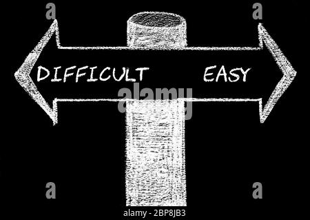 Opposite arrows with Difficult versus Easy. Hand drawing with chalk on ...