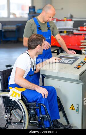 Mechanic working on wheelchair Stock Photo - Alamy