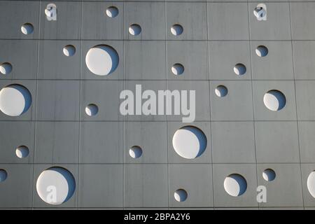Grid in the form of round holes in a silvery plastic panel. Perforated ...