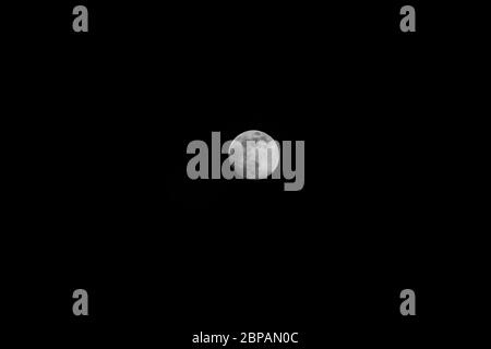almost full moon in the night sky Stock Photo - Alamy