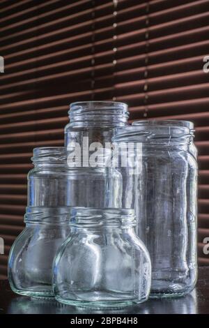 Six empty, used and slightly dirty glass jars Stock Photo - Alamy