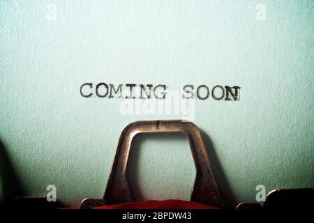 Coming soon text written on a paper Stock Photo - Alamy