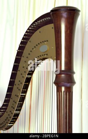 Closeup of the strings and mechanisms of a concert grand, pedal harp ...