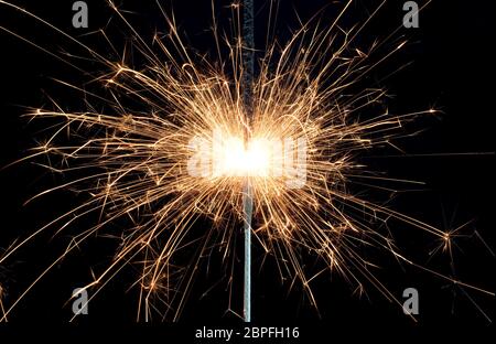 Sparkler isolated on a solid black background Stock Photo - Alamy