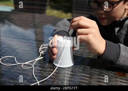 Making a telephone from plastic cups and string, Science Experiment at ...