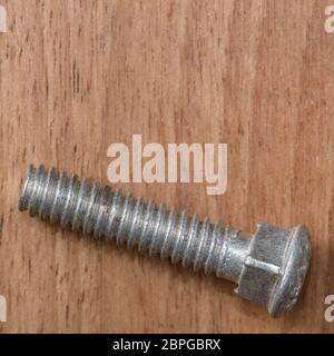 One bolt on wood blur background Stock Photo - Alamy
