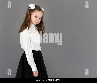 The child is angry at homework. An elementary school student is tearing ...