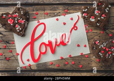 Calendar with date 14 FEBRUARY and cookies on table in living room ...