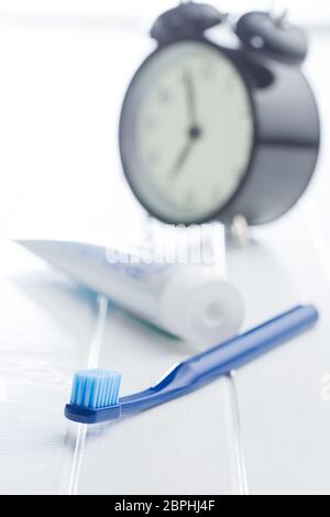 Toothbrush and alarm clock Stock Photo - Alamy