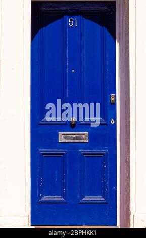 House number 51 on a royal blue wooden front door with vertical lines ...