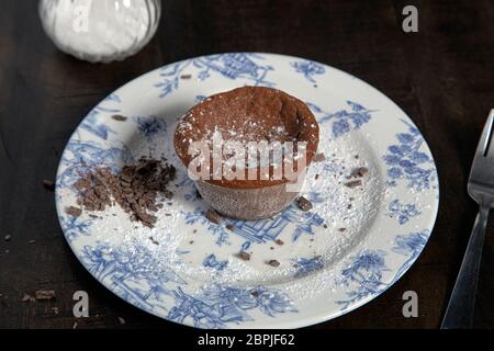 Coulant chocolate cake on wooden table Stock Photo - Alamy