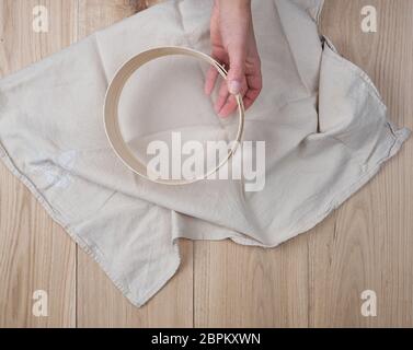empty round wooden sieve in hand, top view Stock Photo - Alamy