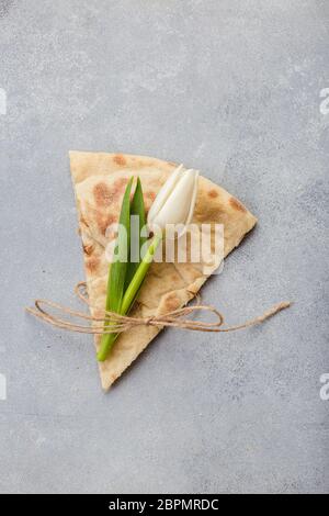 smiling woman with tulips on grey background Stock Photo - Alamy