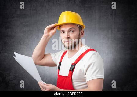 Confused construction worker trying to understand documents Stock Photo ...