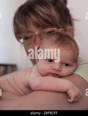 Mom comforts newborn Stock Photo - Alamy